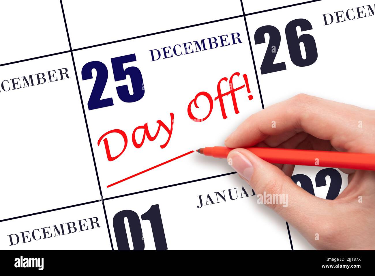 25th day of December. Hand writing text DAY OFF and drawing a line on ...
