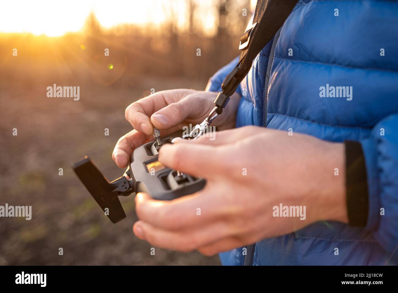 Person holding remote controller Stock Photo - Alamy
