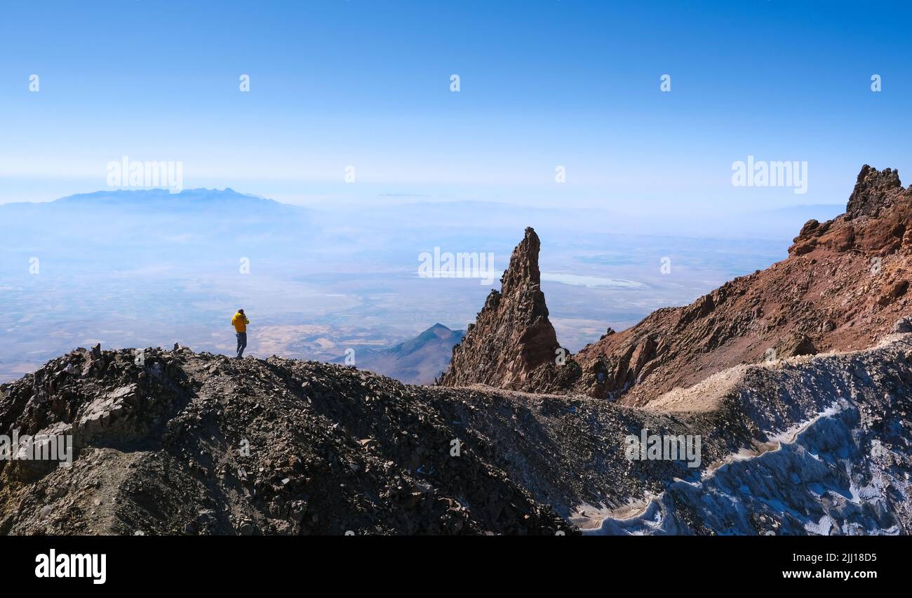 Tourist climbing volcanic mountain rock hi-res stock photography and ...
