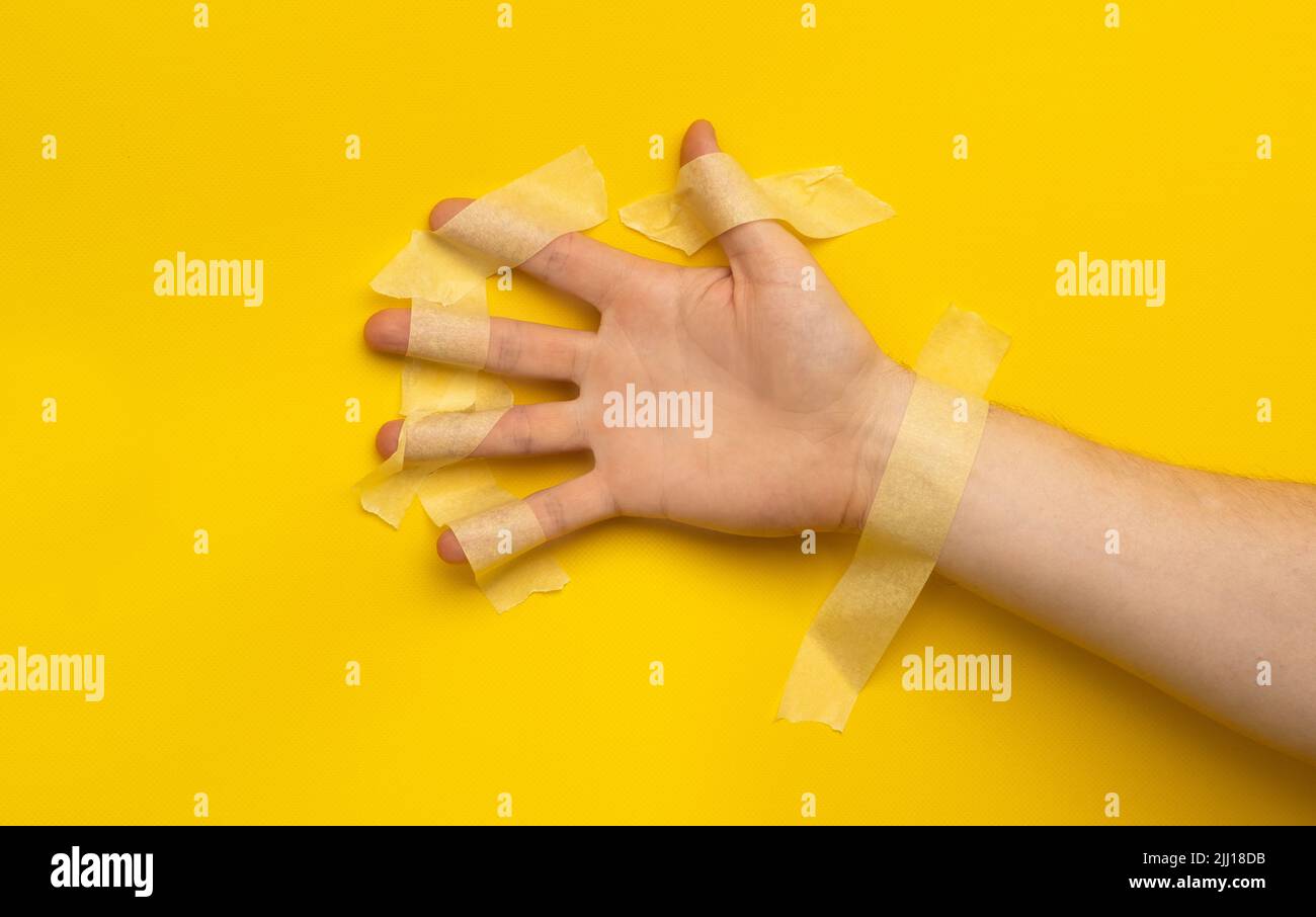 Hand with masking tape Stock Photo - Alamy