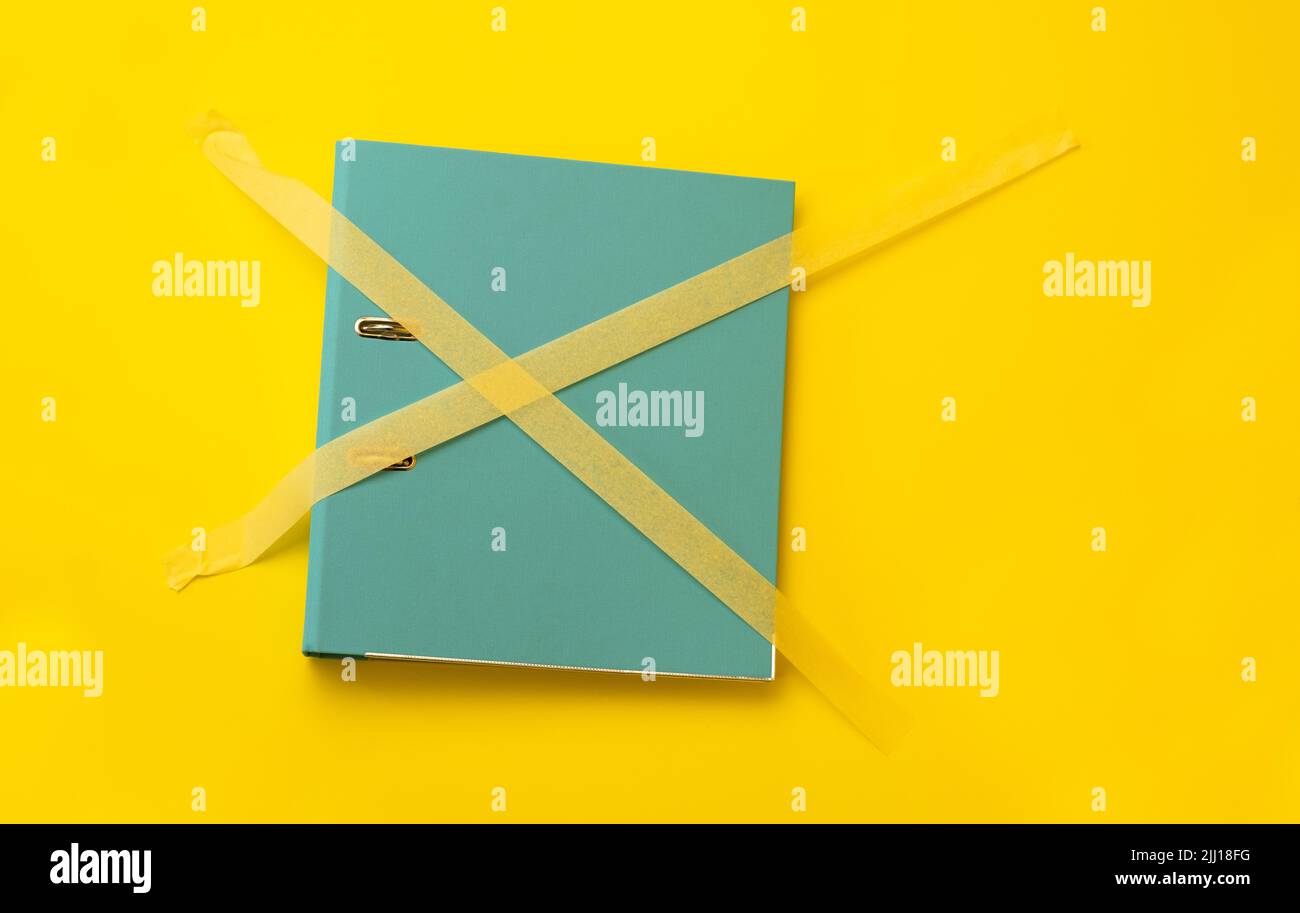 Folder sticked up with masking tape Stock Photo - Alamy