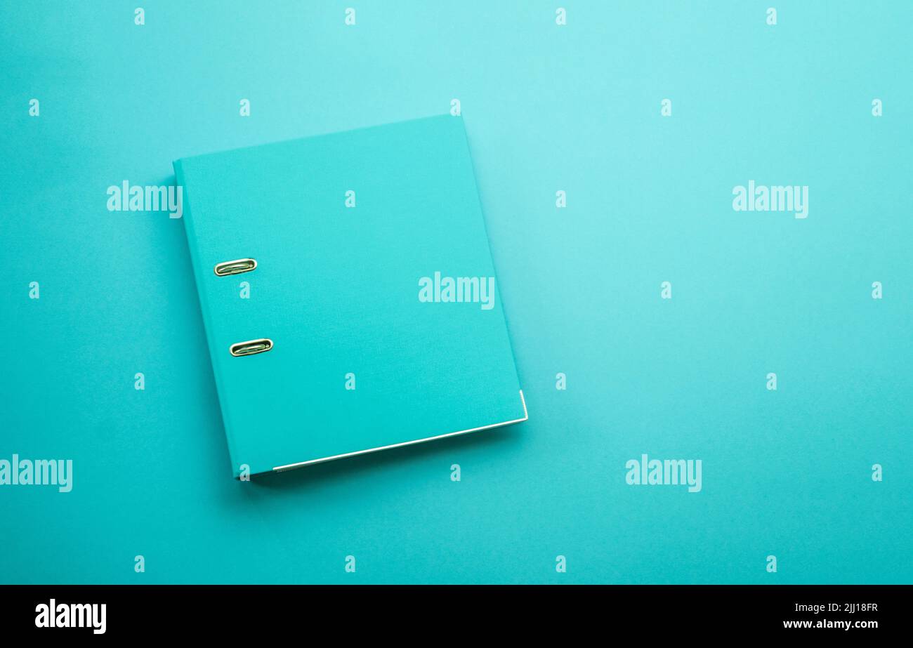 Hardcover folder on blue background Stock Photo - Alamy