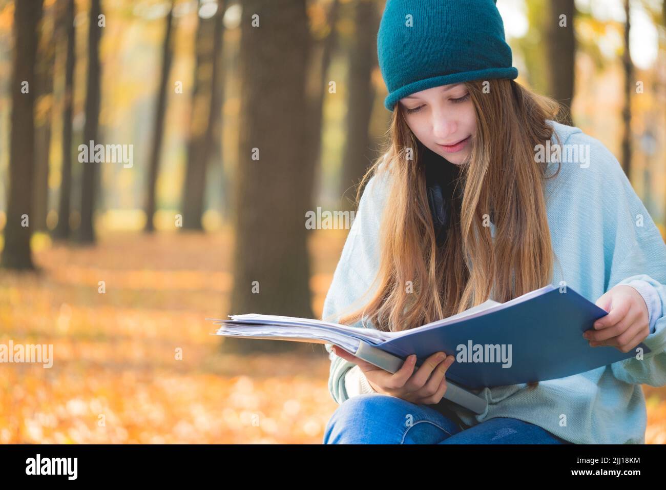 Nice student reading textbook Stock Photo - Alamy