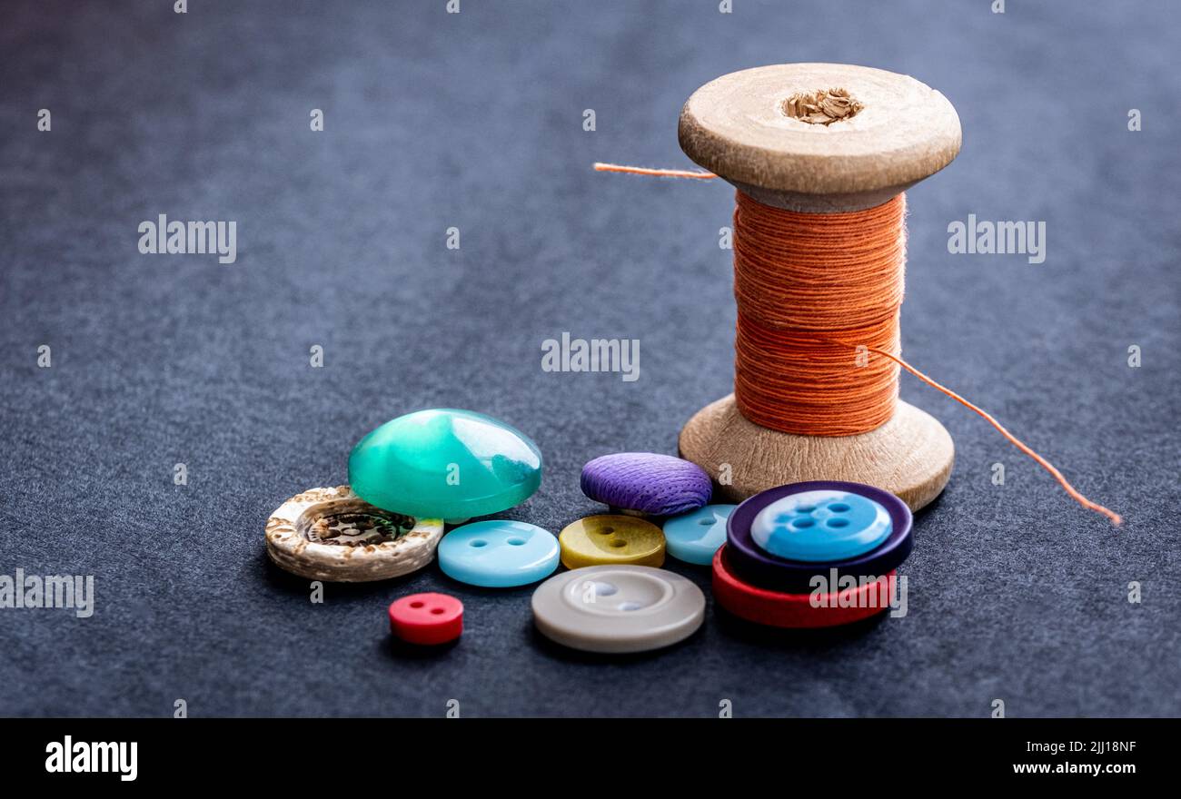 Sewing buttons and thread spool Stock Photo - Alamy