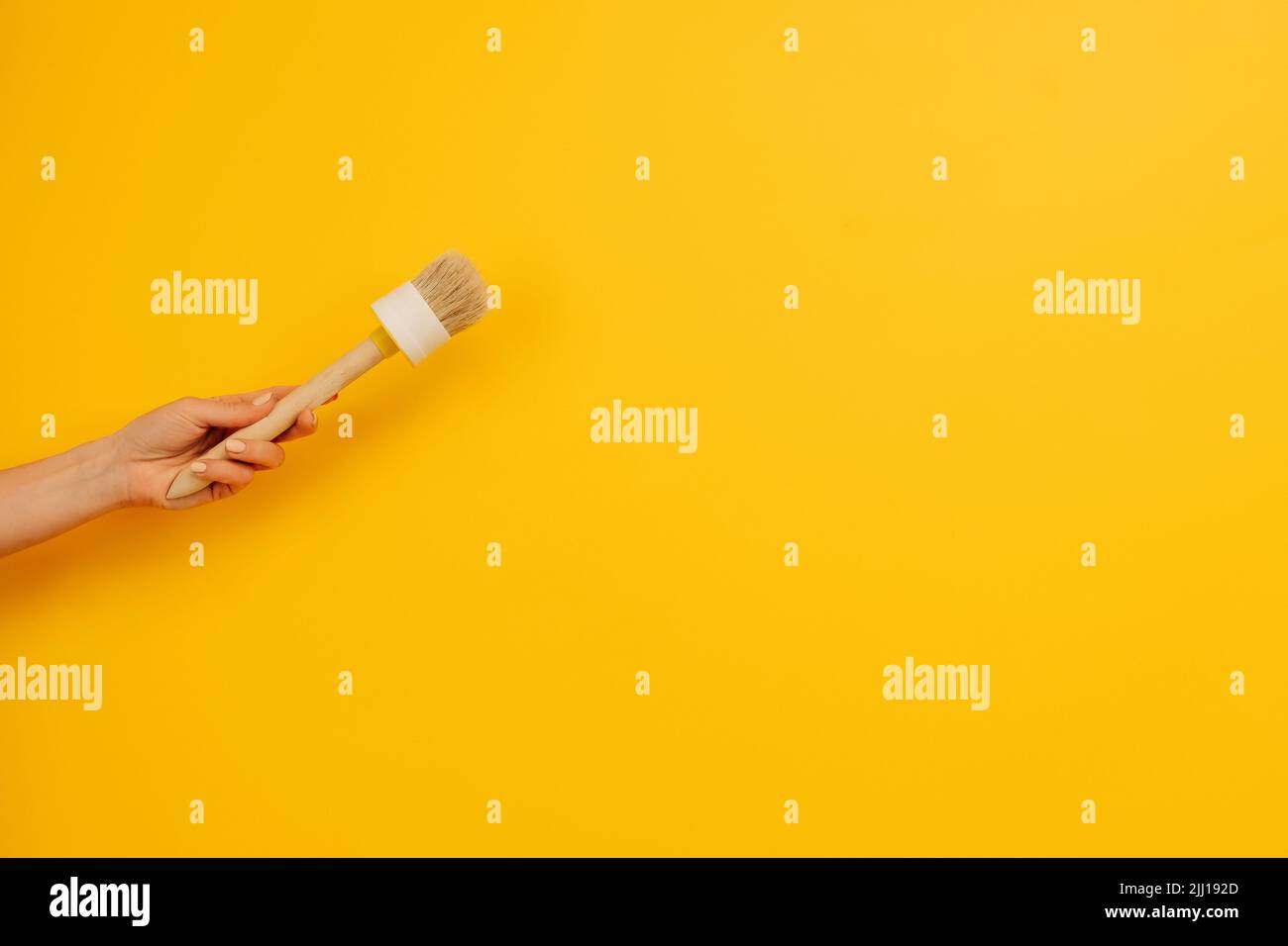 Hand holding paint brush Stock Photo - Alamy