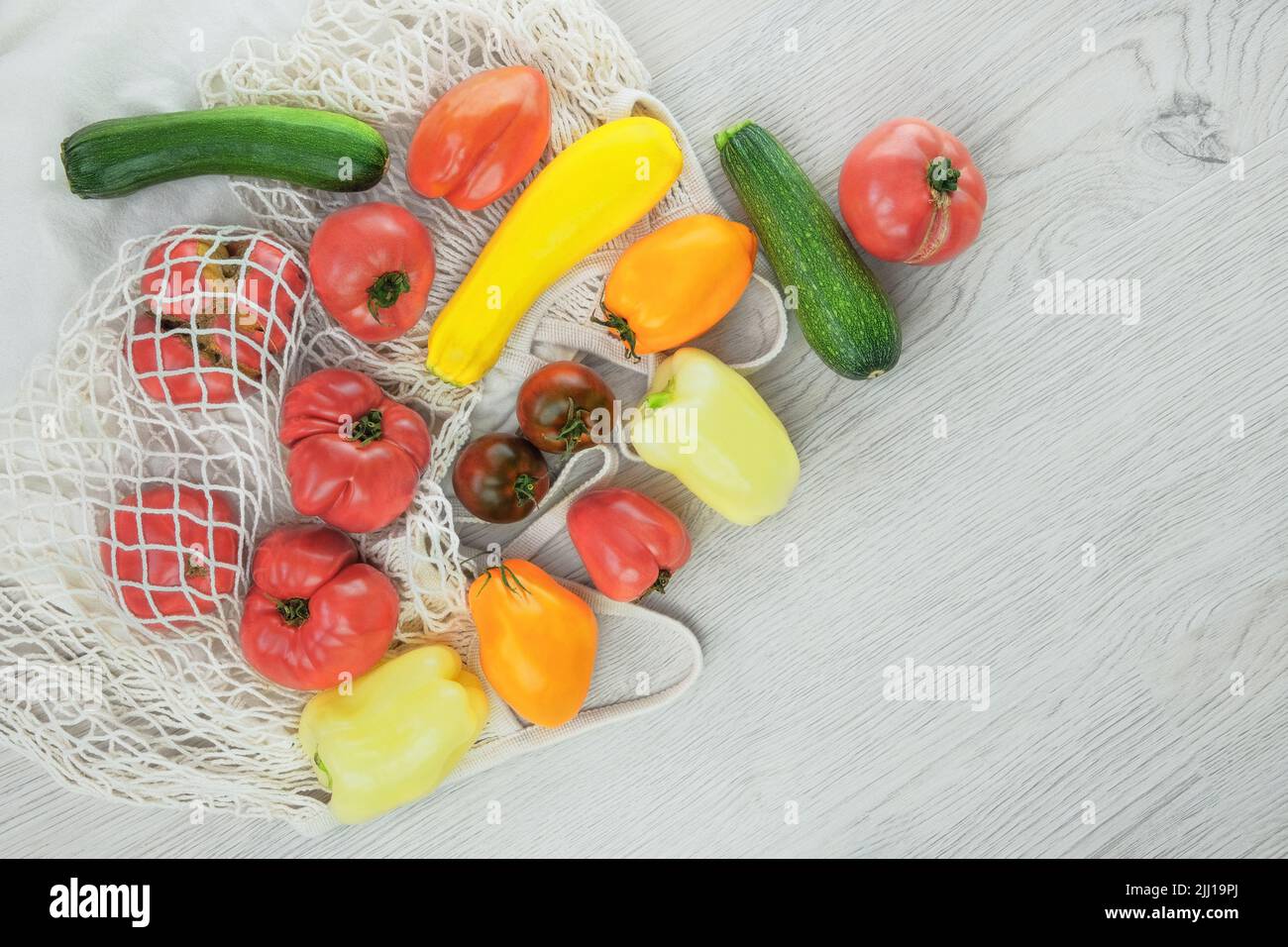Various farming tomatoes, peppers, zucchini on a white wooden ...