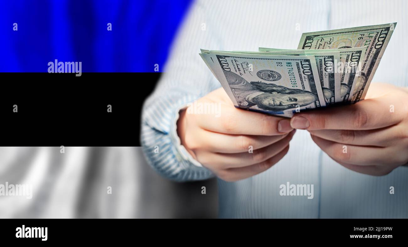 Blue, black and white color Estonian flag and US dollars money in human ...