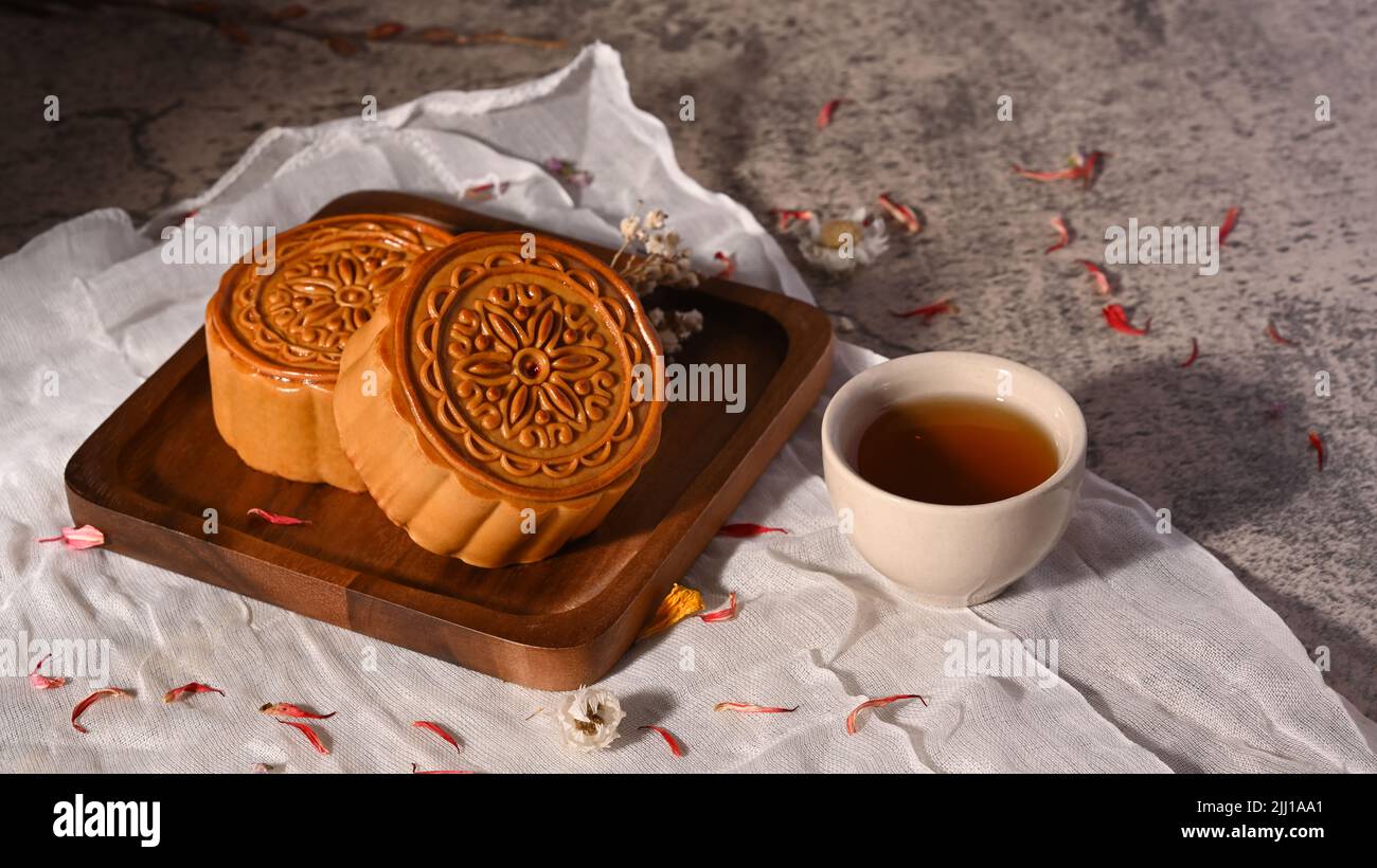 Mid autumn festival mooncake and cup of tea on stone table Stock Photo ...