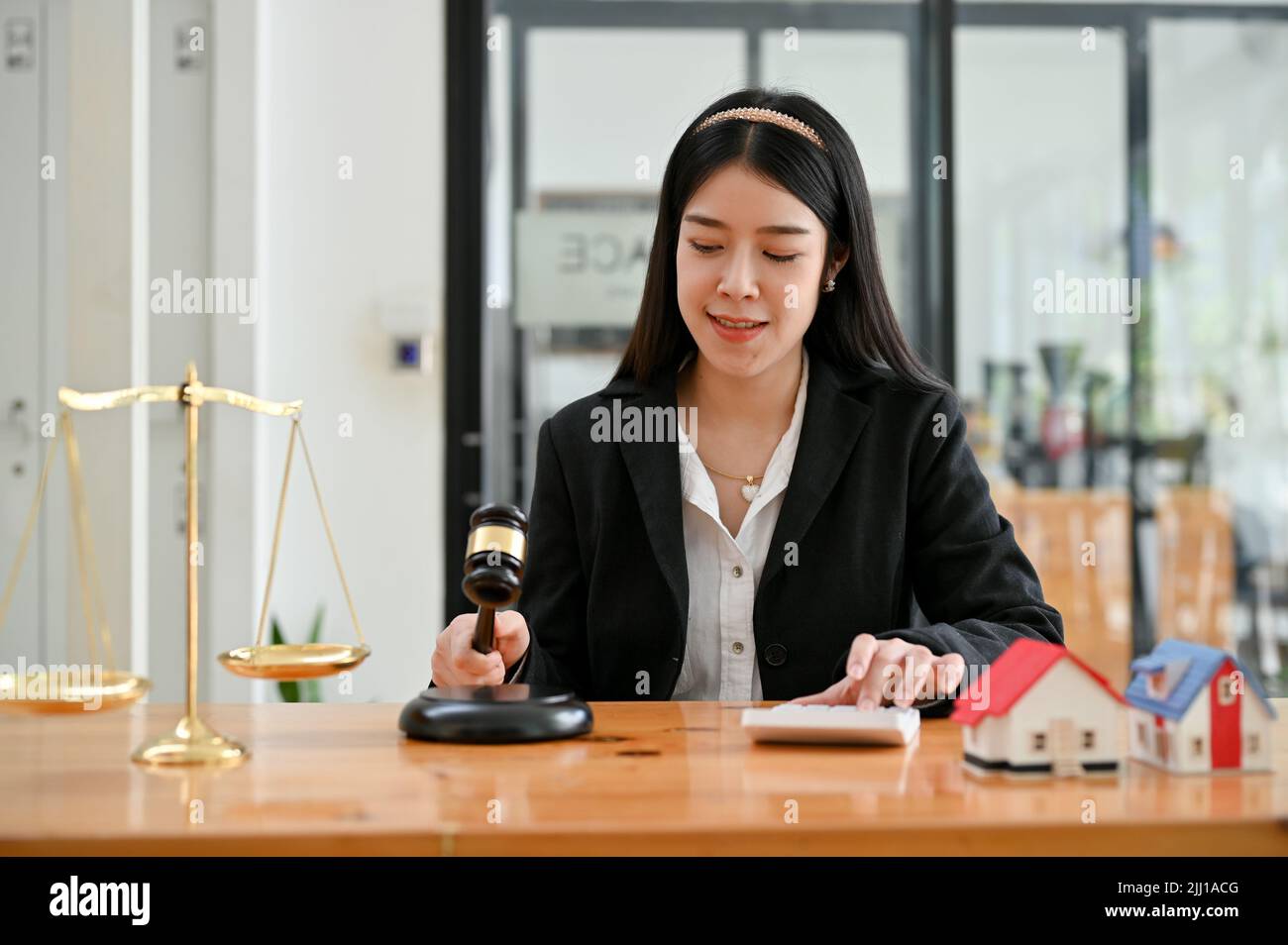 Confident and professional young Asian female lawyer or business law consultant in formal suit ...