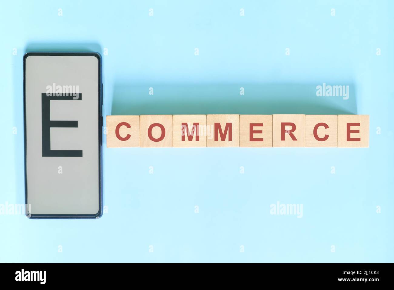 E-commerce business concept. Hand holding mobile phone with word on ...