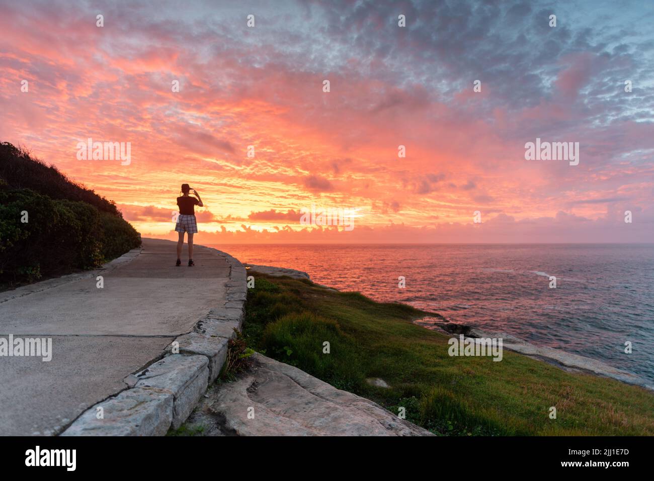 girl take a photo of the beautiful sun rise in the morning in sydney ...