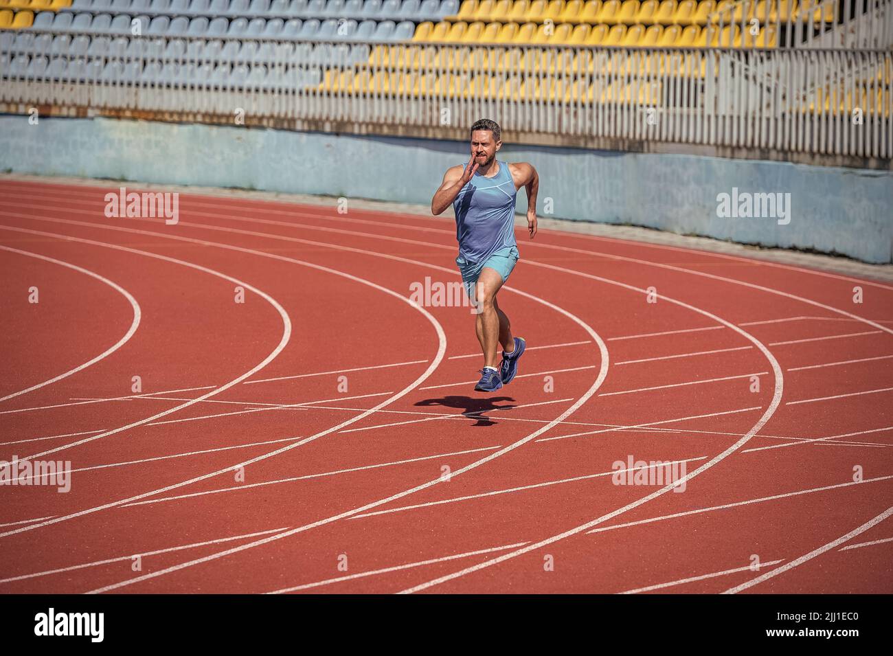athletic muscular man runner running on stadium, speed Stock Photo - Alamy