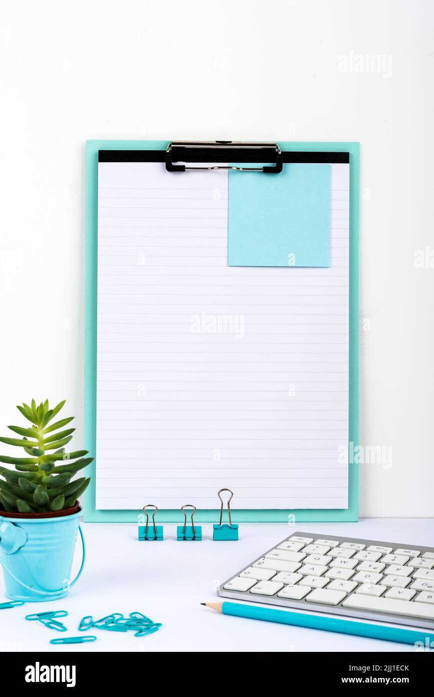 Important Message Presented On Clipboard On Desk With Pot With Flower ...