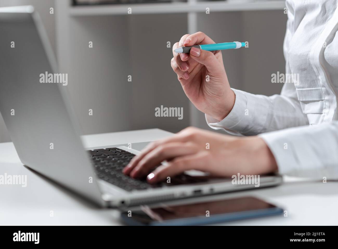 Businesswoman Typing Recent Updates On Lap Top Keyboard On Desk With ...