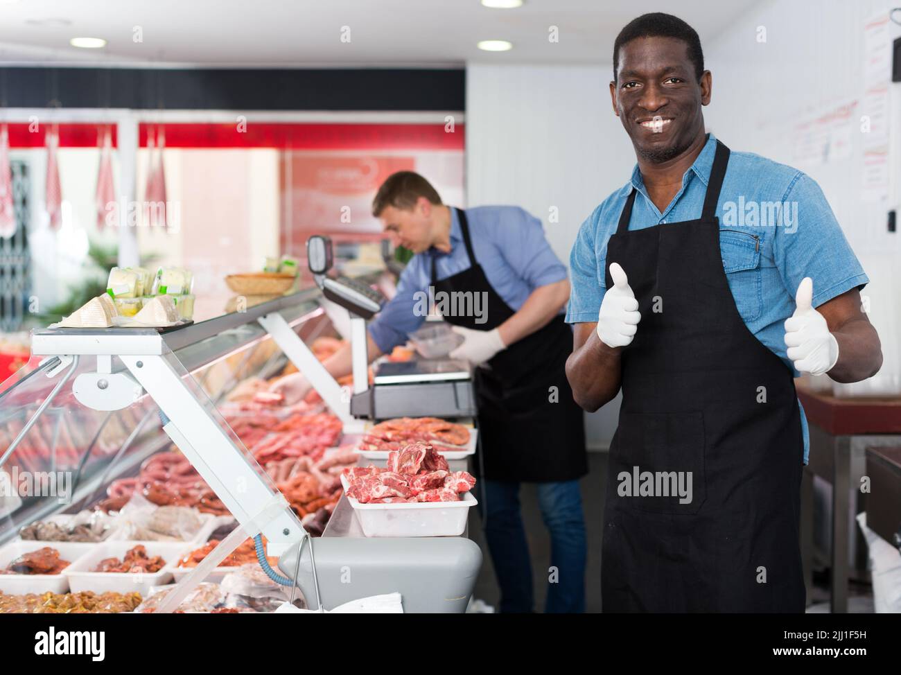 African American butcher giving thumbs up Stock Photo - Alamy