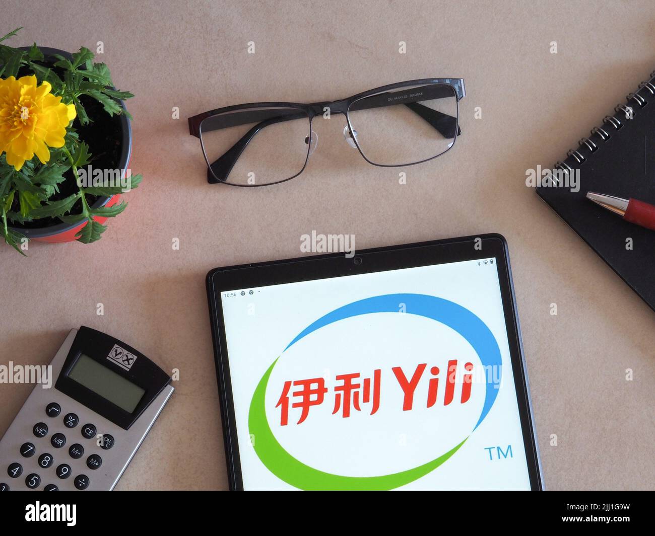 In this photo illustration, the Yili Group logo seen displayed on a ...