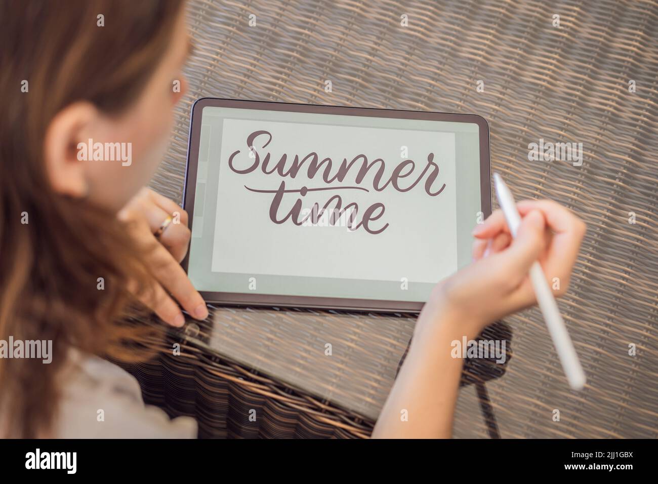 Calligrapher Young Woman writes phrase on digital tablet. Inscribing ...