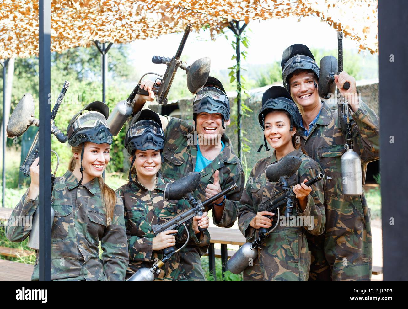 Portrait of paintball players wearing uniform and holding guns ready ...