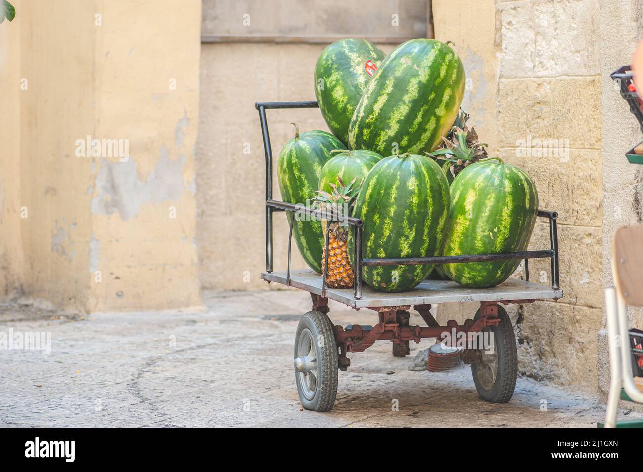 Big watermelons with pineapples in a cart in a street food market in ...
