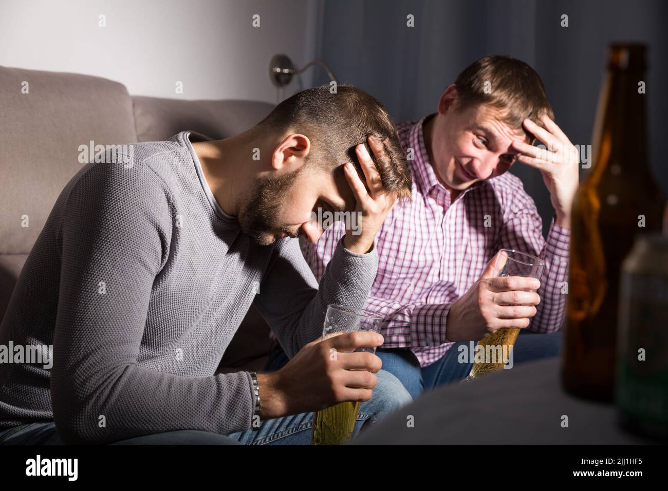 Frustrated men watching matchup on tv Stock Photo - Alamy