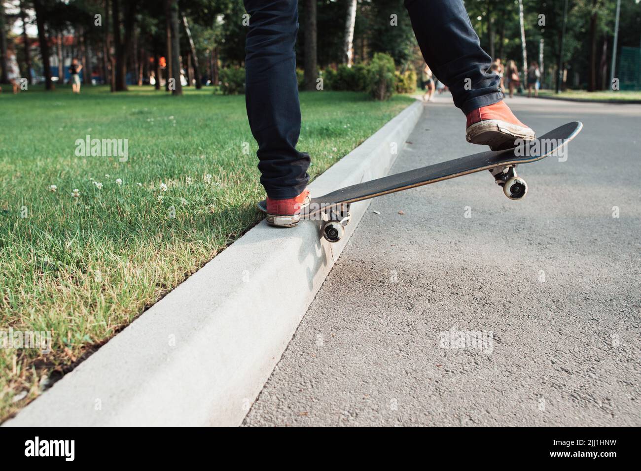 Skateboarder make back slide trick on park Stock Photo - Alamy