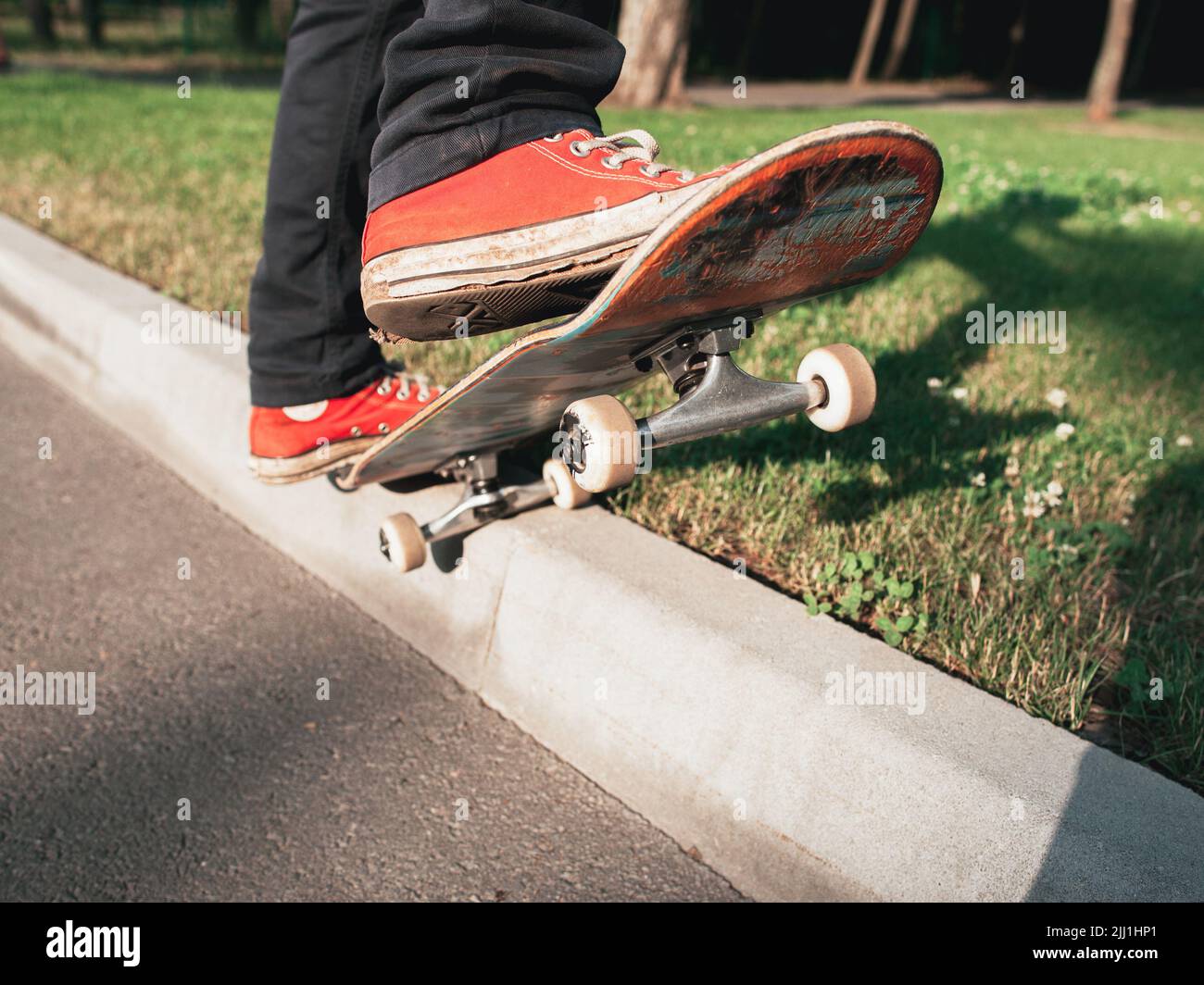 Skateboarder make back slide trick on park Stock Photo - Alamy