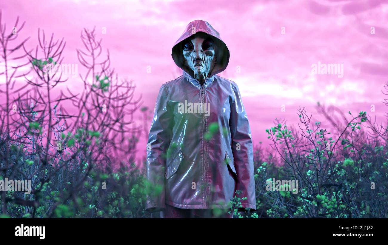 Portrait of spooky alien in field under colorful neon light. Scary mask ...