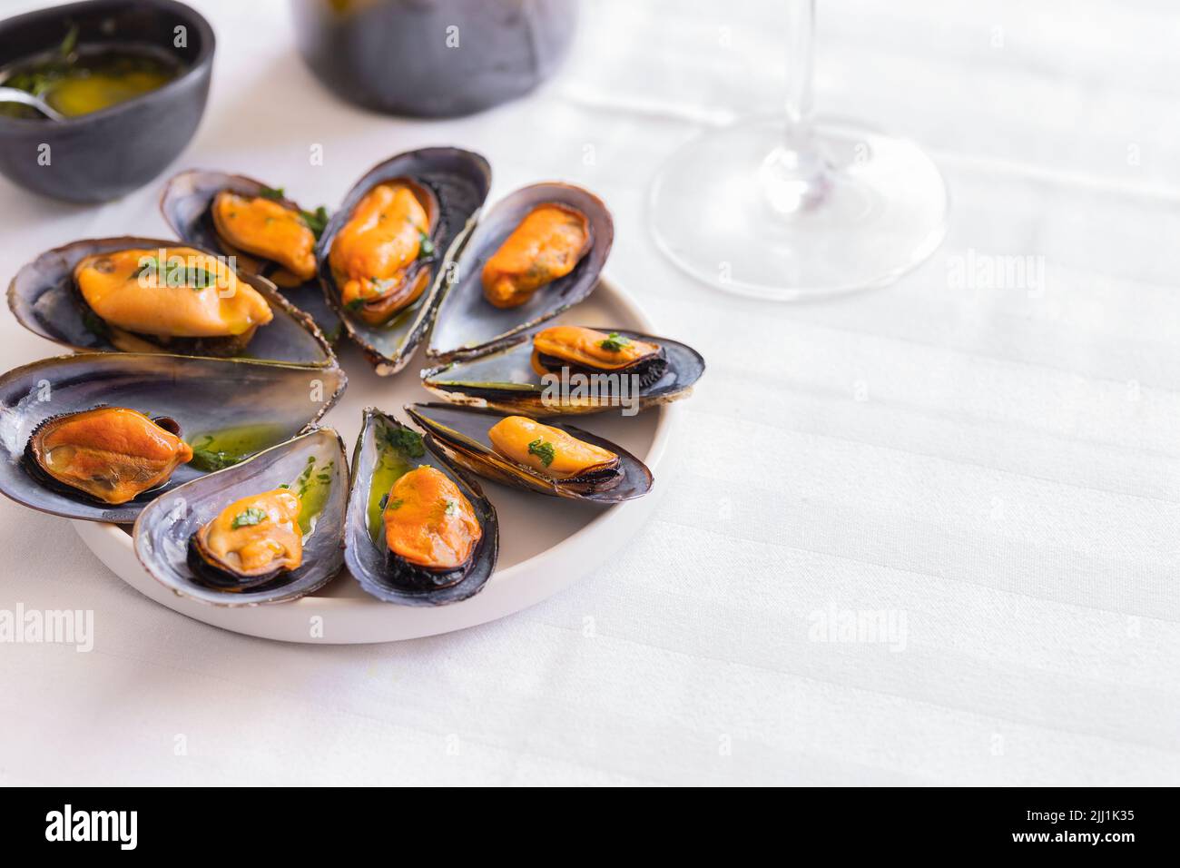 Steamed black mussels cooking in sauce and served with wine. Popular ...
