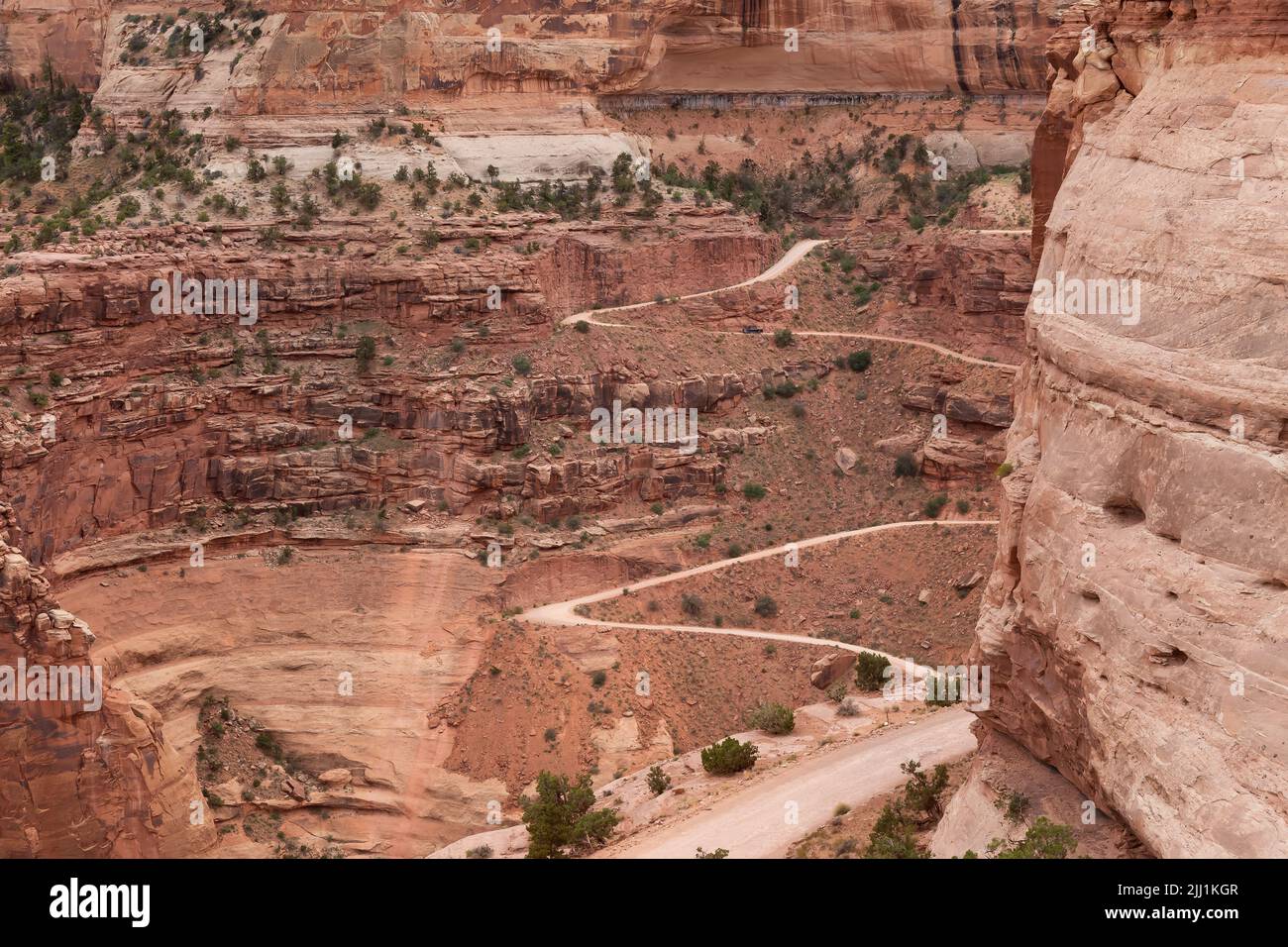 Scenic Dirt Road surrounded by Red Rock Mountains in Desert Canyon ...