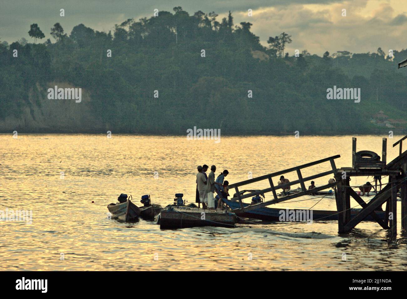 People on a boat jetty on Segah river in Tanjung Redeb, Berau, East ...