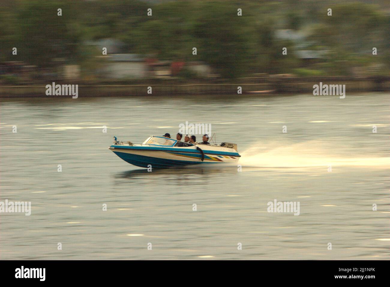 A speedboat carrying passengers on Segah river in Tanjung Redeb, Berau ...