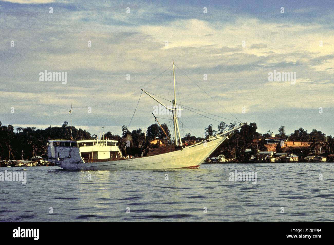 A traditional phinisi boat sailing on Segah river in Tanjung Redeb ...
