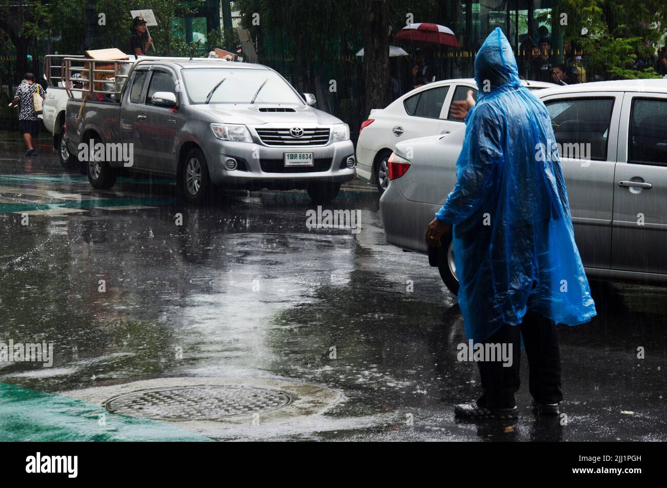 Thai officer operator volunteer staff wear rain suit working control ...