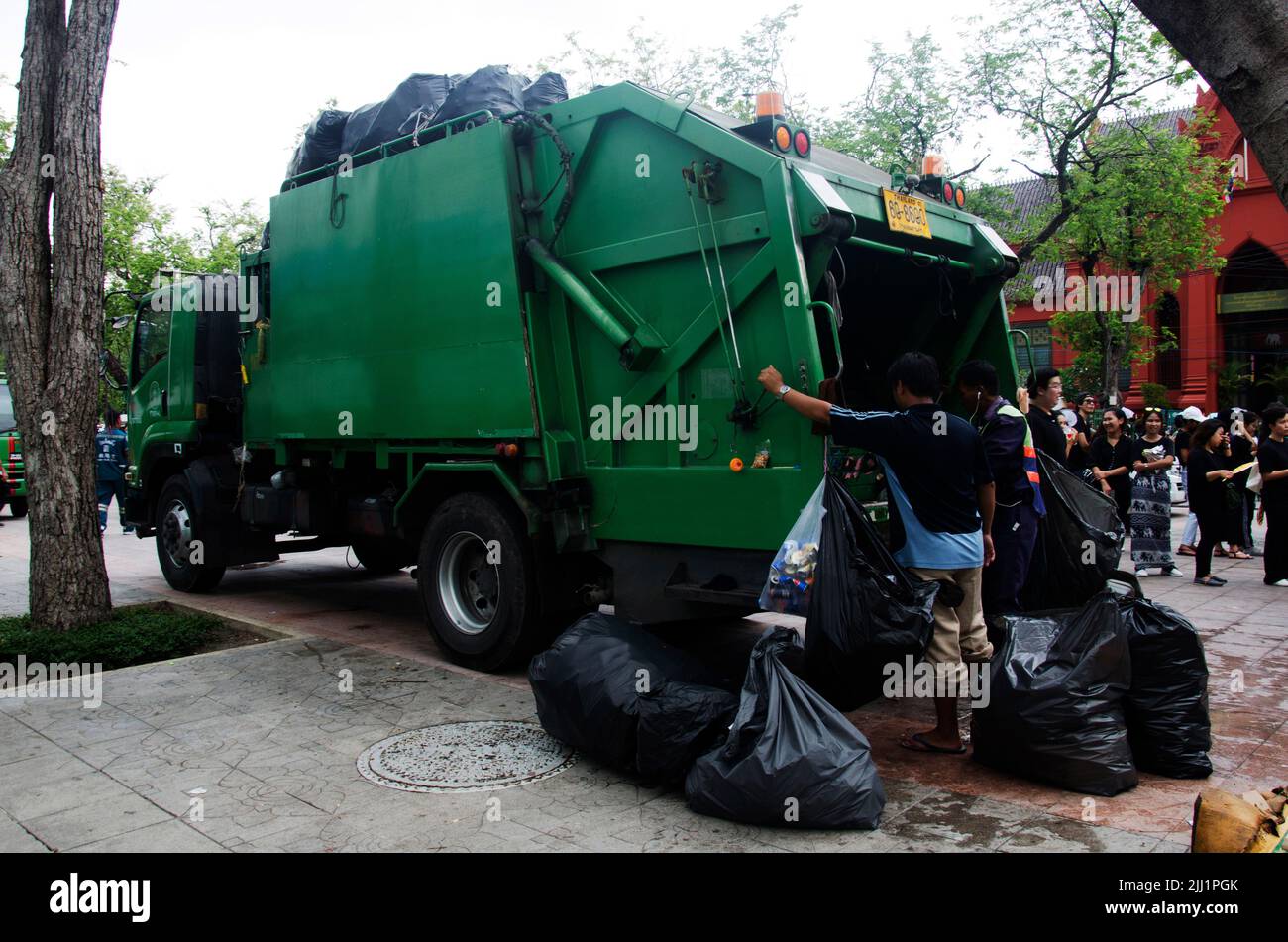 Thai cleaner officer operator working keeping waste junk removal in bin ...