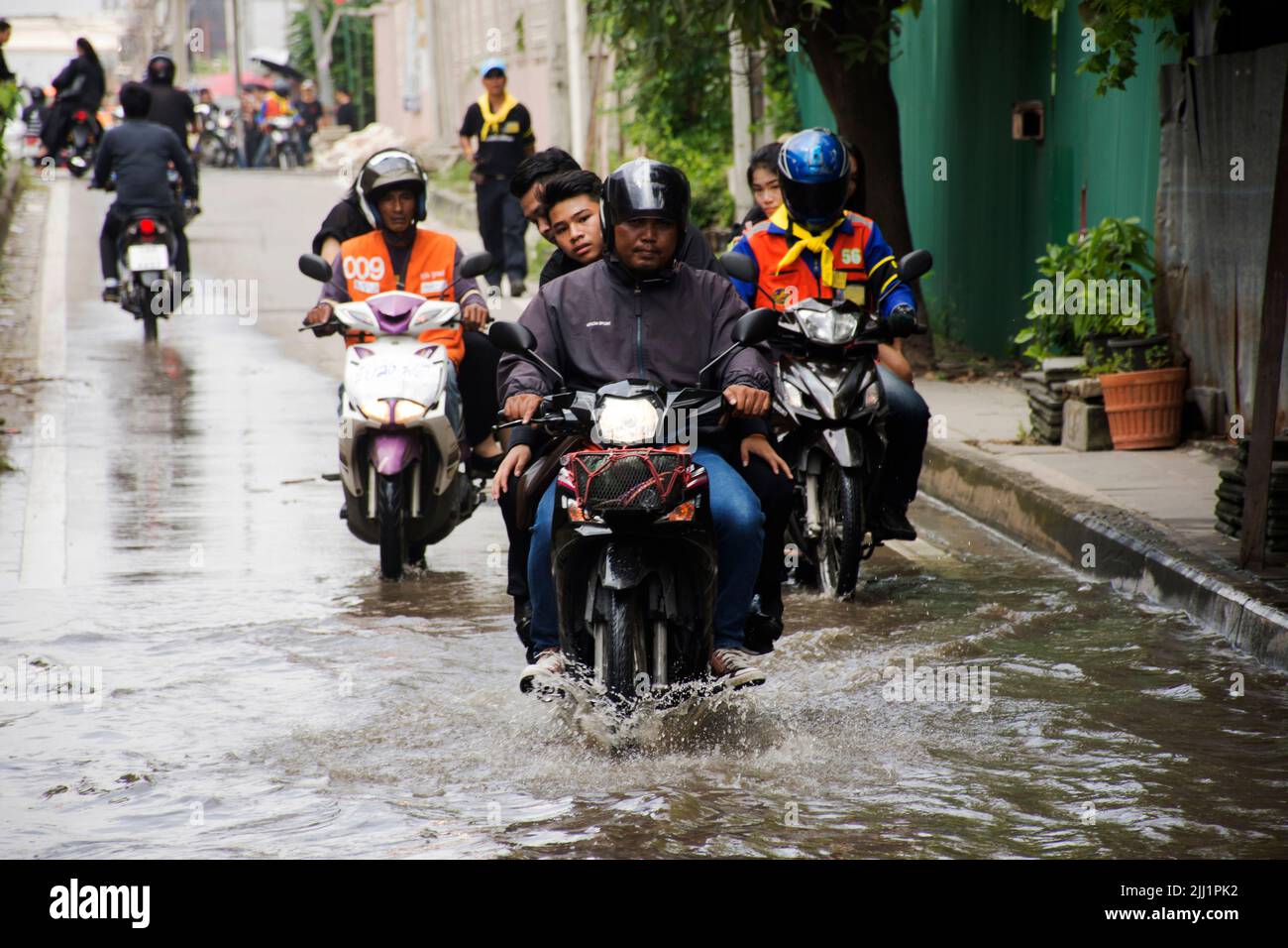 Thai rider riding motorcycle and motorbike taxi on street send receive ...