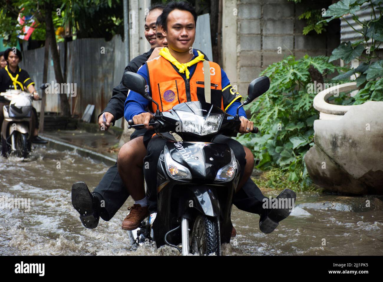 Thai rider riding motorcycle and motorbike taxi on street send receive ...