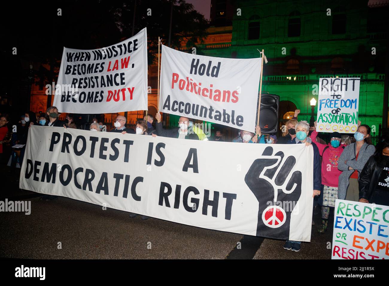 Protesters carry banners and signs during a rally against new anti ...