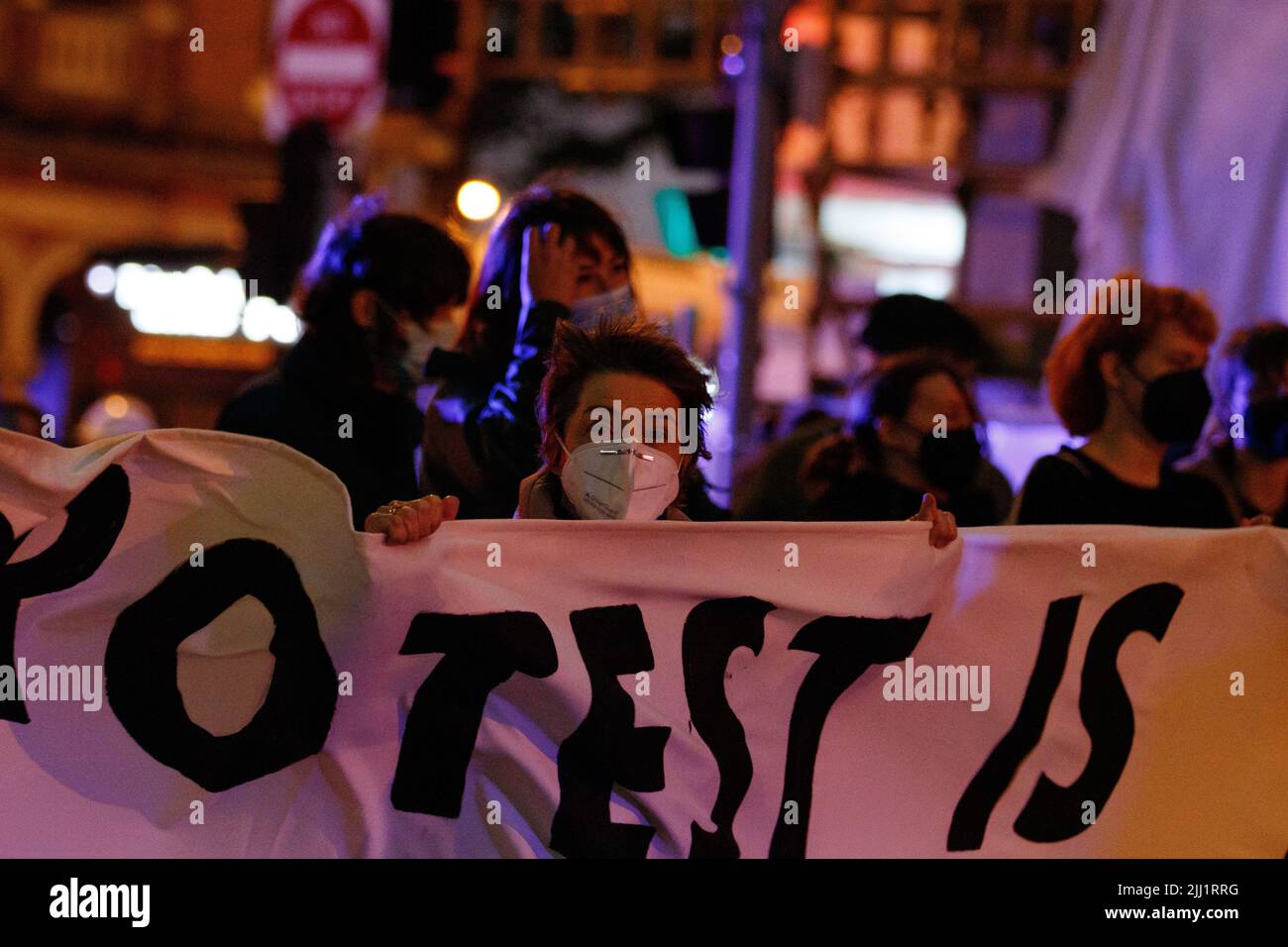 Protesters carry banners and signs during a rally against new anti ...