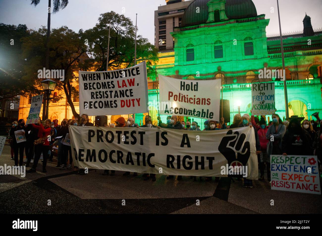 Protesters carry banners and signs during a rally against new anti ...