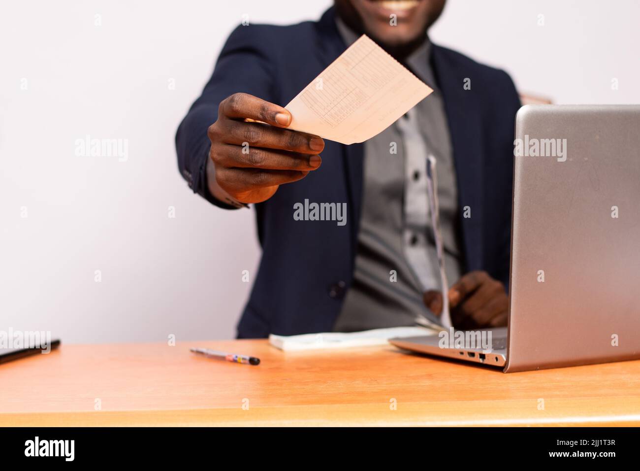 african businessman giving someone a check Stock Photo - Alamy