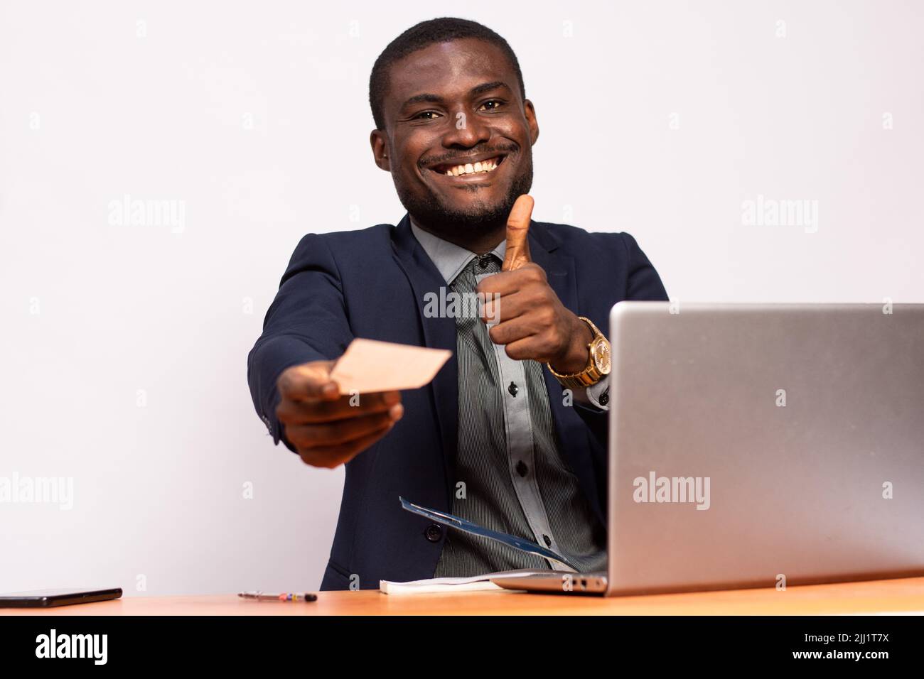 african businessman giving someone a check Stock Photo - Alamy