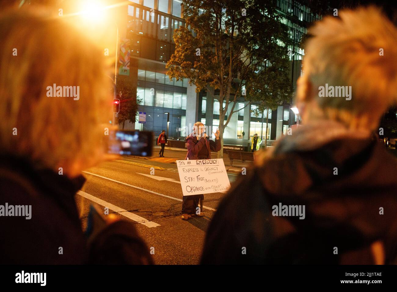 A protester speaks to the crowd at the culmination of a rally against ...