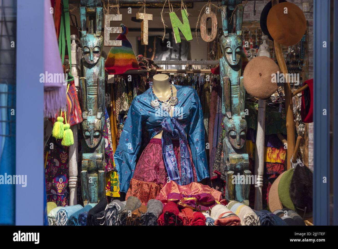 Ethno shop, window of souvenir store with statues and clothes. Ethno ...