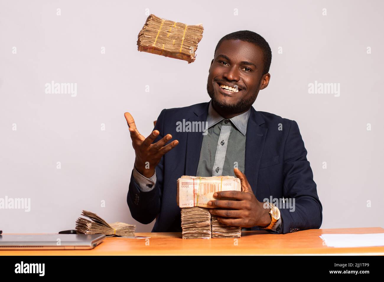 happy african businessman with lots of money Stock Photo - Alamy