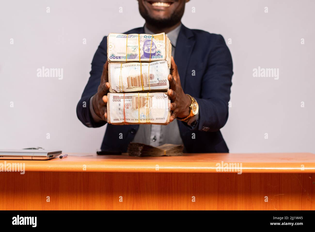 african businessman holding a bundle of cash Stock Photo - Alamy