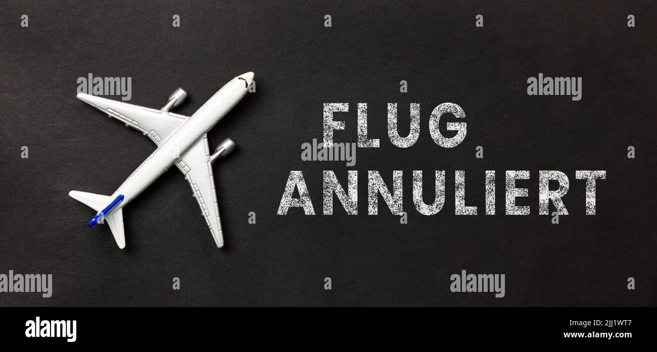 A white plane flight on a black background with German text 'flug ...