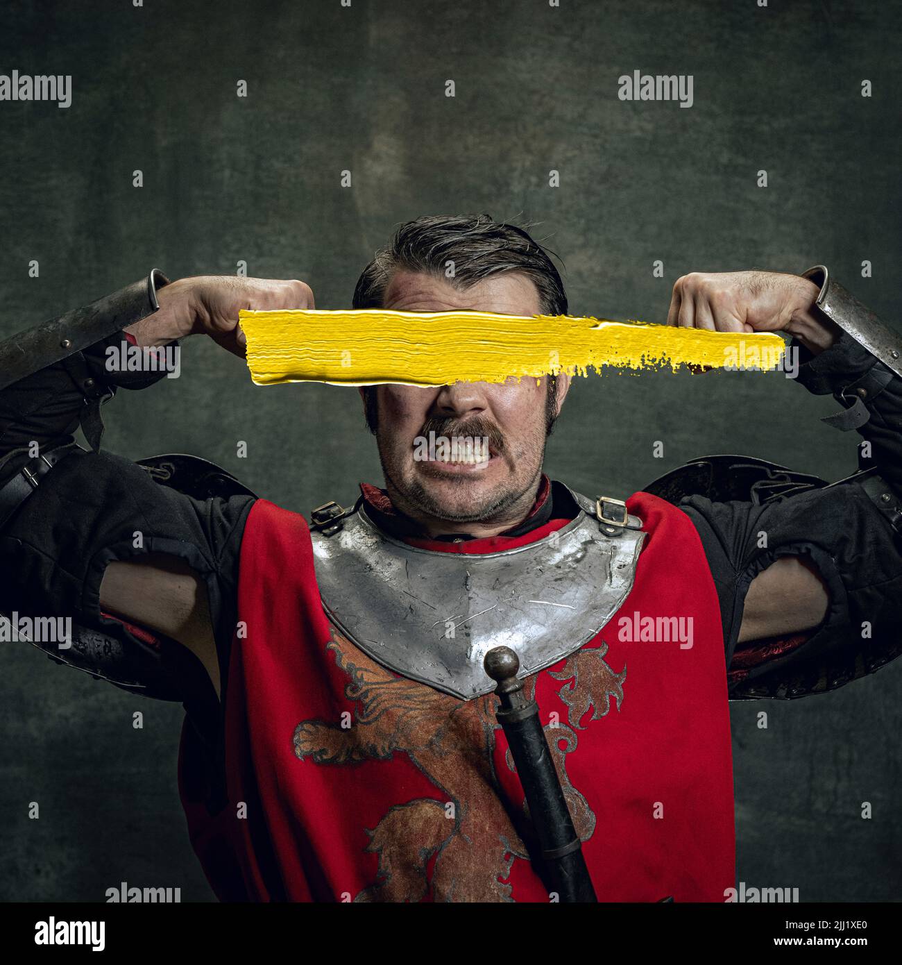 Artwork. Young man as medieval warrior, knight isolated on dark vintage ...