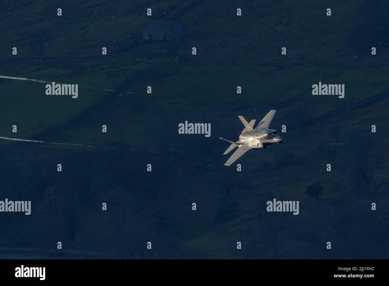 A top view of a fighter jet in flight over the Ullswater, UK Stock ...