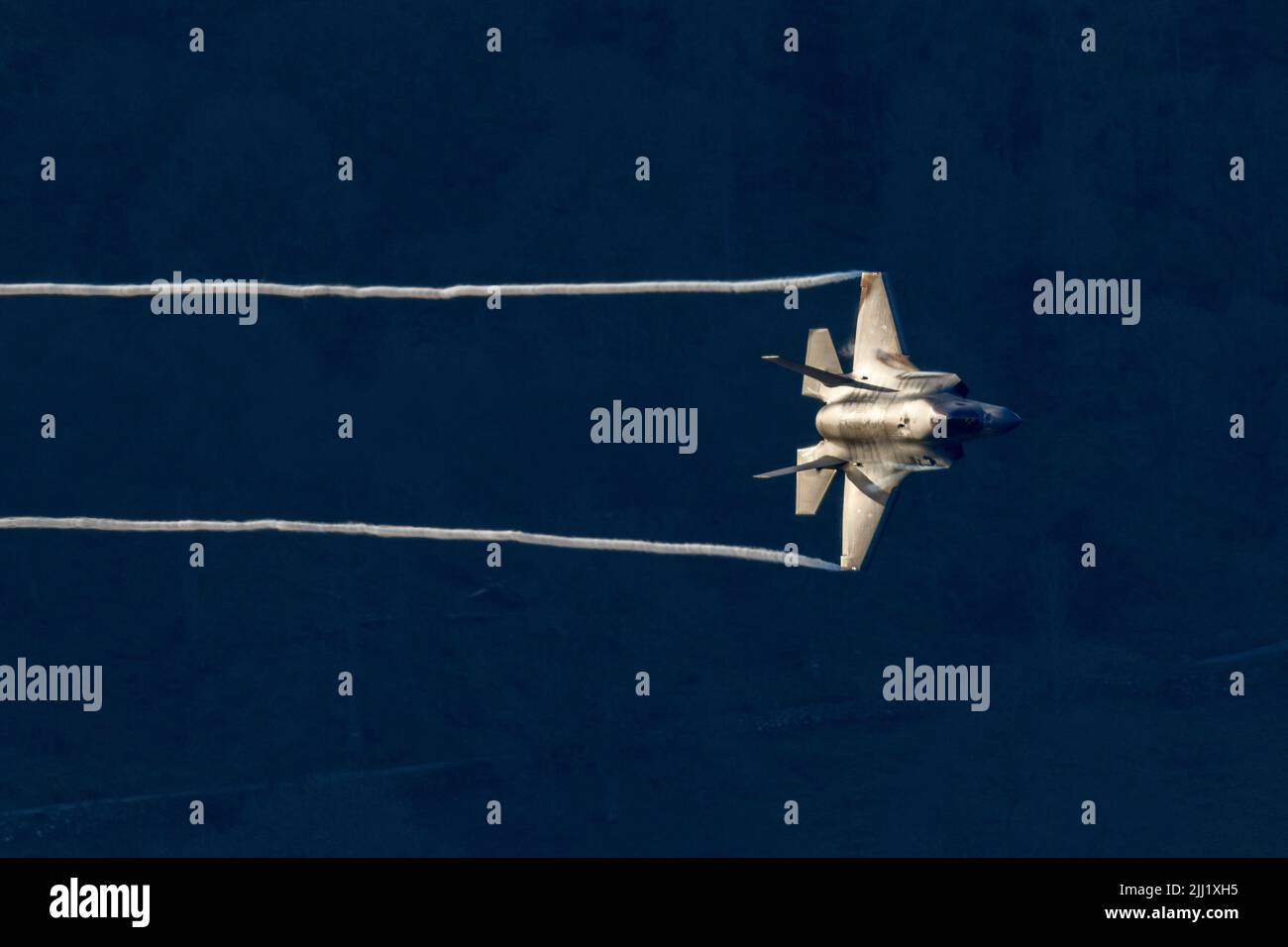 A top view of a fighter jet in flight over the Ullswater, UK Stock ...