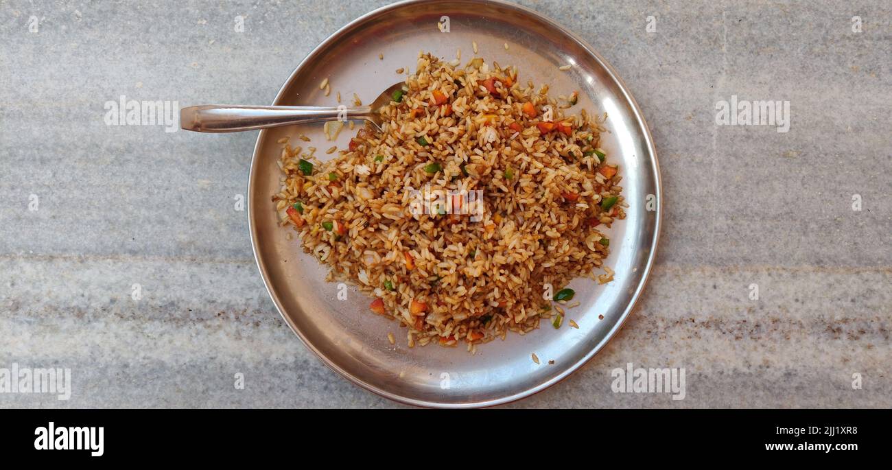Veg Schezwan Fried Rice in plate. Vegetarian Szechuan Rice is indo ...